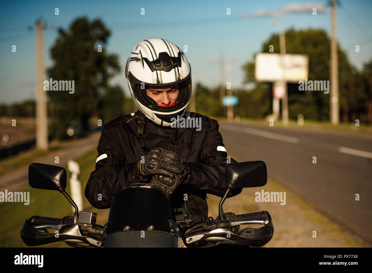 Close shot of a motorbiker in the helmet Stock Photo - Alamy