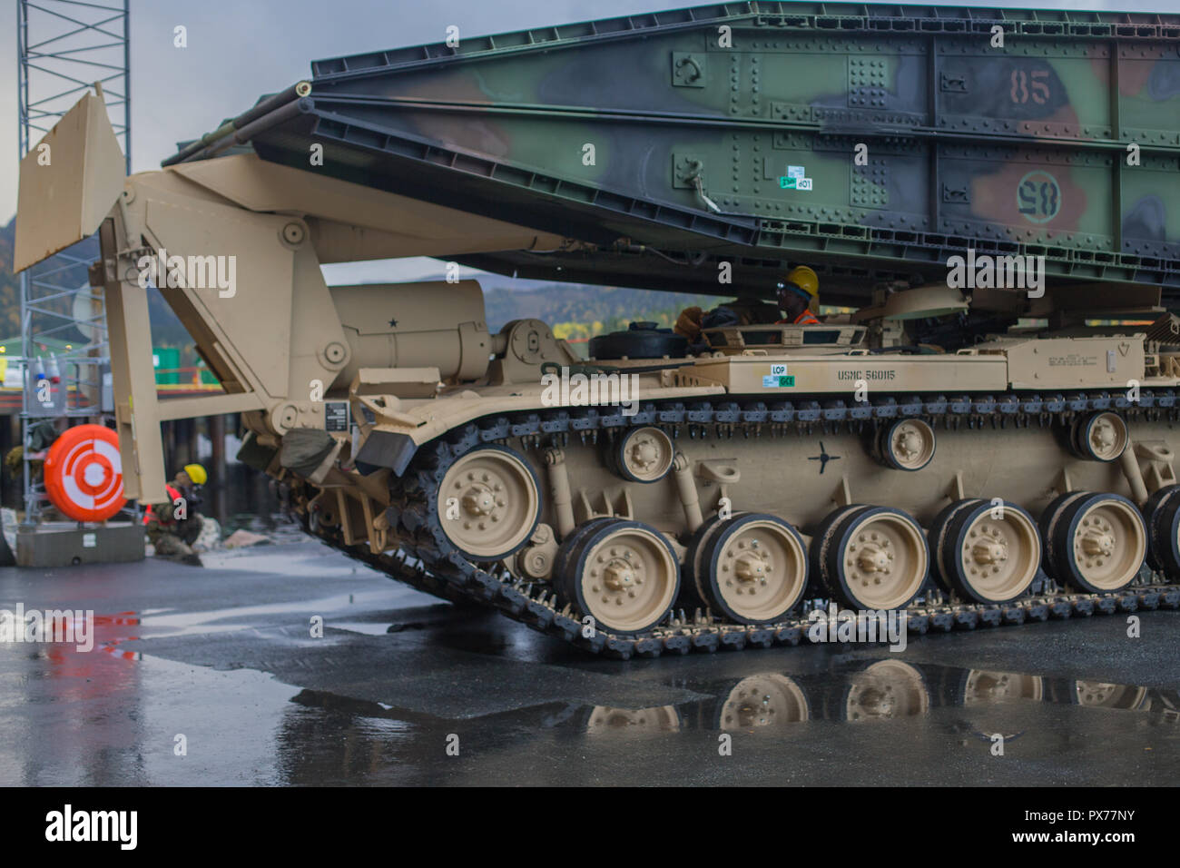 U.S. Marines disembark an armored vehicle launched bridge from the USNS ...