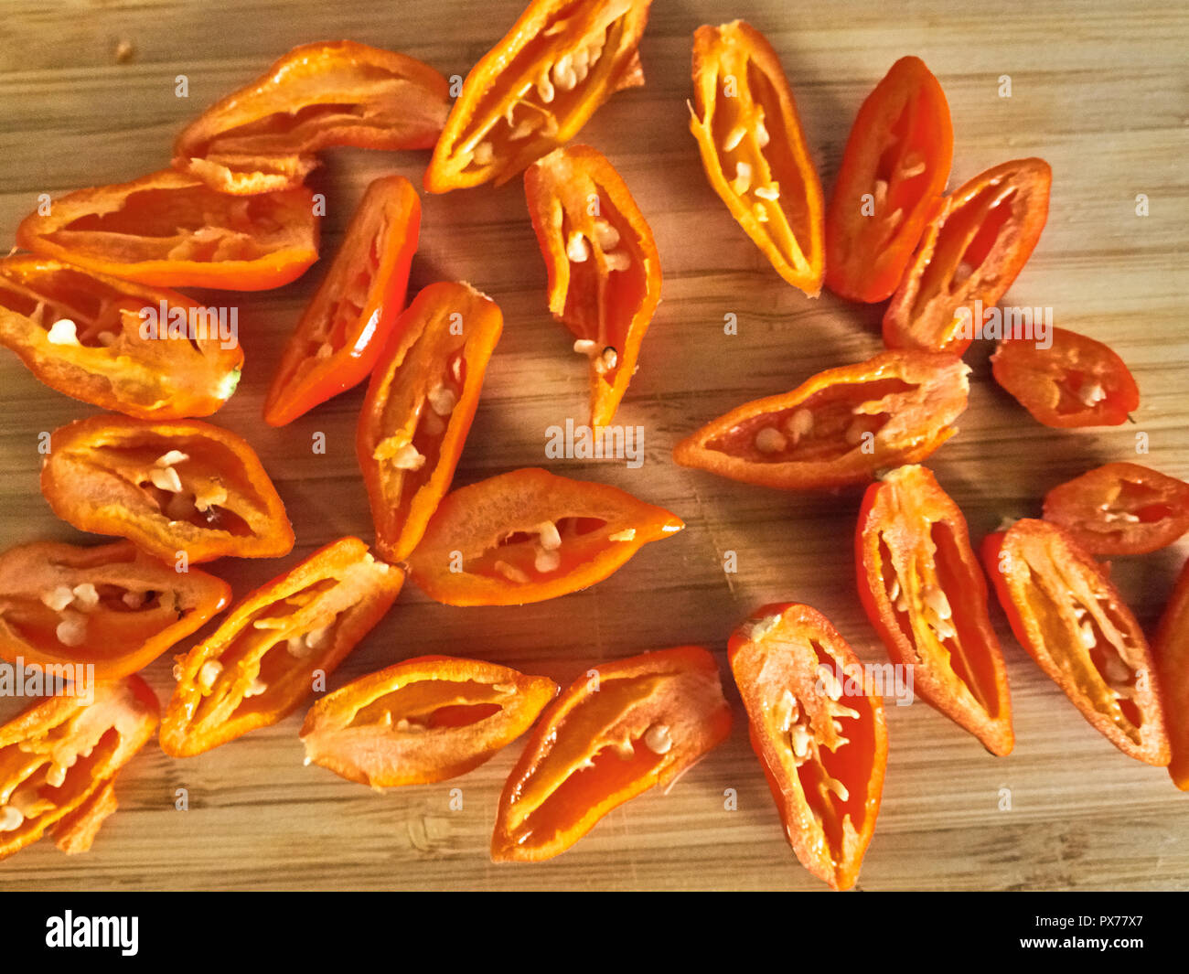 Shot of orange Naga Morich Peppers on a cutting board Stock Photo - Alamy