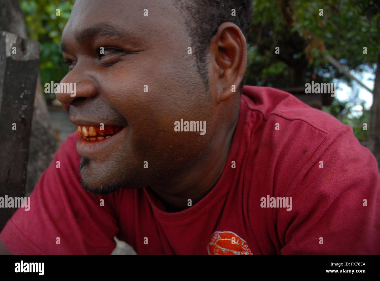 Man with red teeth after chewing betel nuts, Honiara, Solomon Islands ...