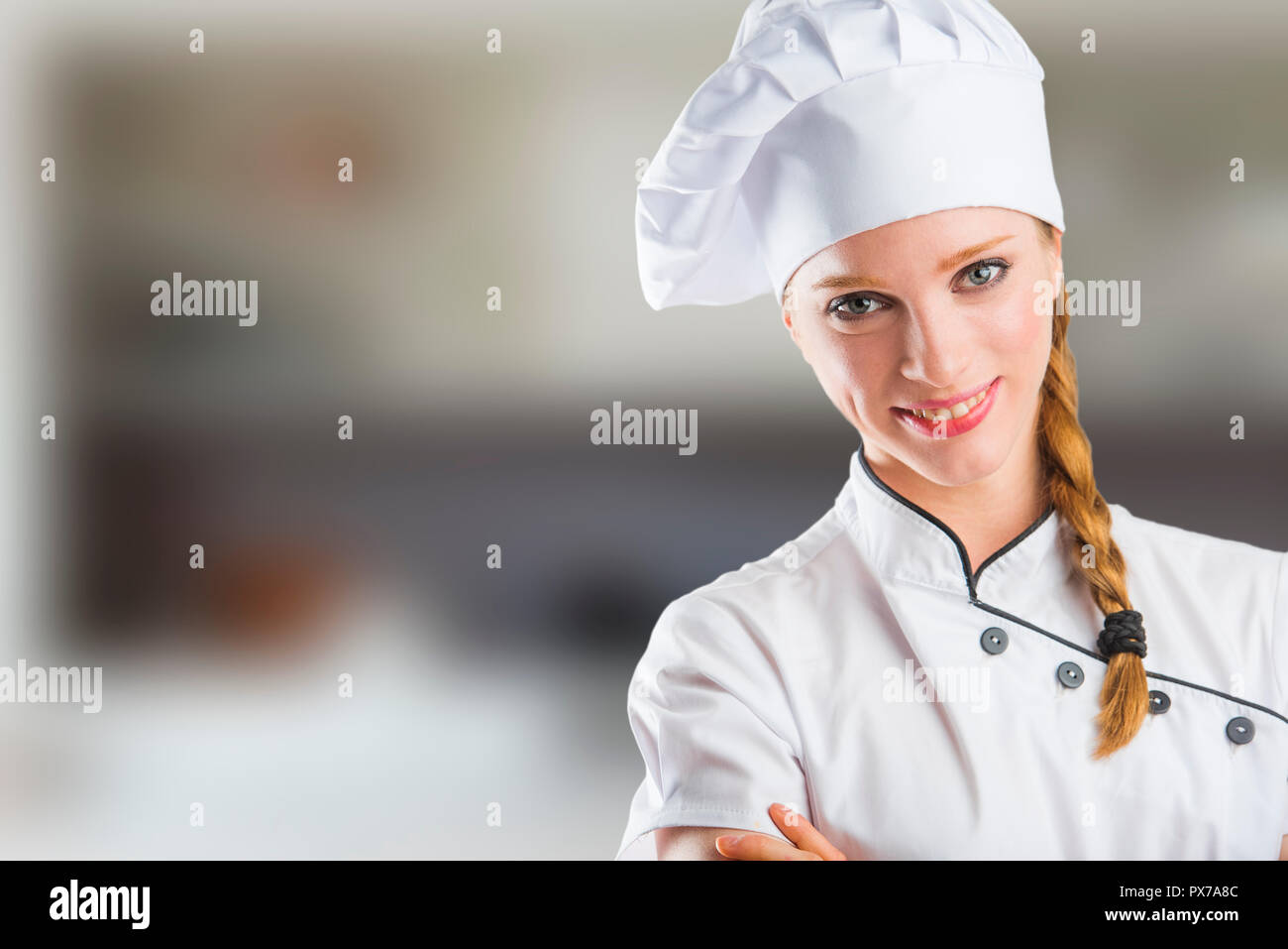 A beautiful woman chef is smiling for the camera, close up, isolated ...