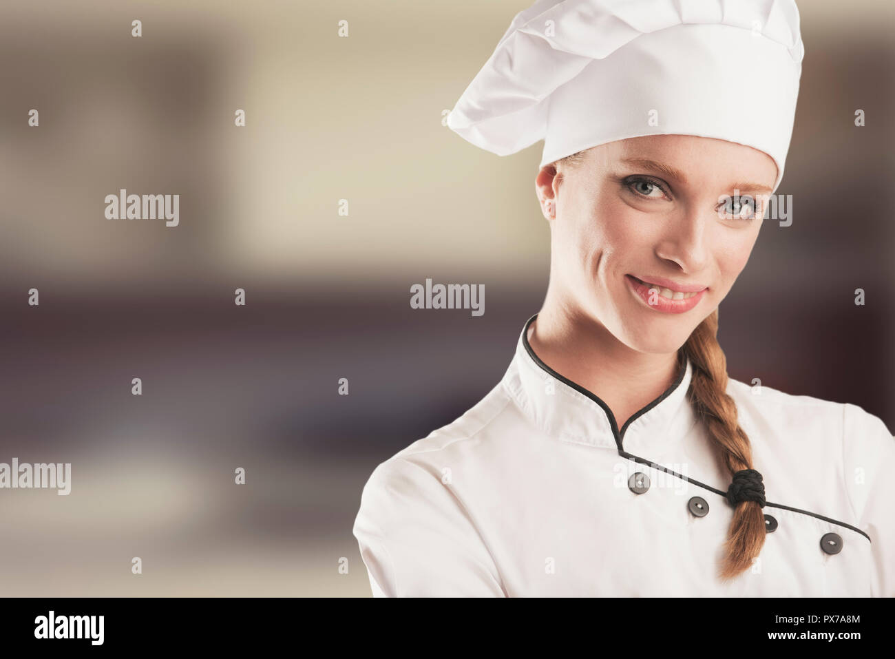 A beautiful woman chef is smiling for the camera, close up, isolated ...