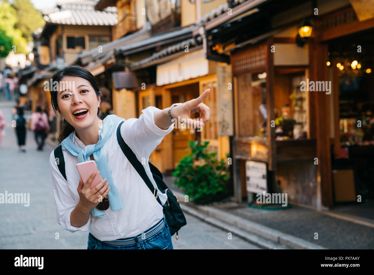 tourist standing on the Japanese traditional street and joyfully ...