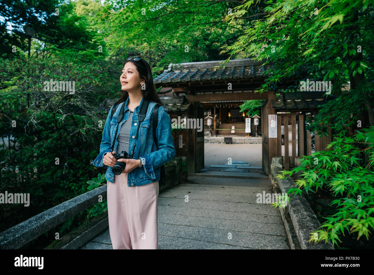 beautiful tourist standing in front of the temple and ready to take ...