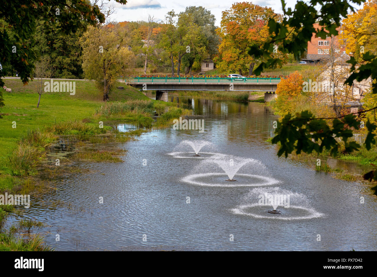 Dobele, Latvia. Autumn city landscape with river, bridge and fountains ...