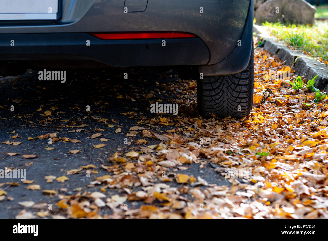 Season tire change. Car with new winter tires on the road for autumn ...