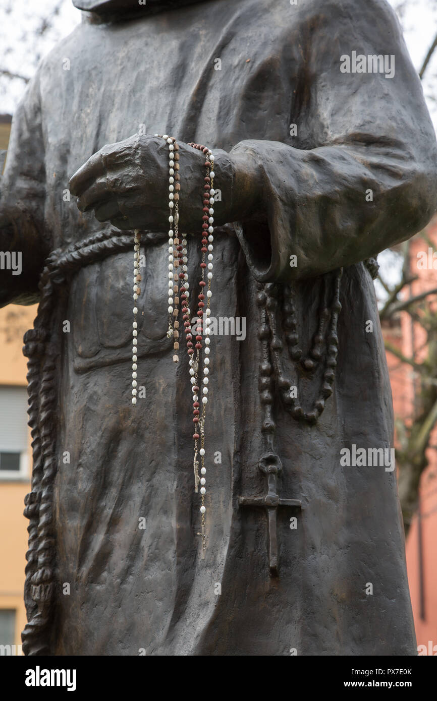 Bronze Statue of a Saint with Catholic Rosary Hanging Along the Arm ...