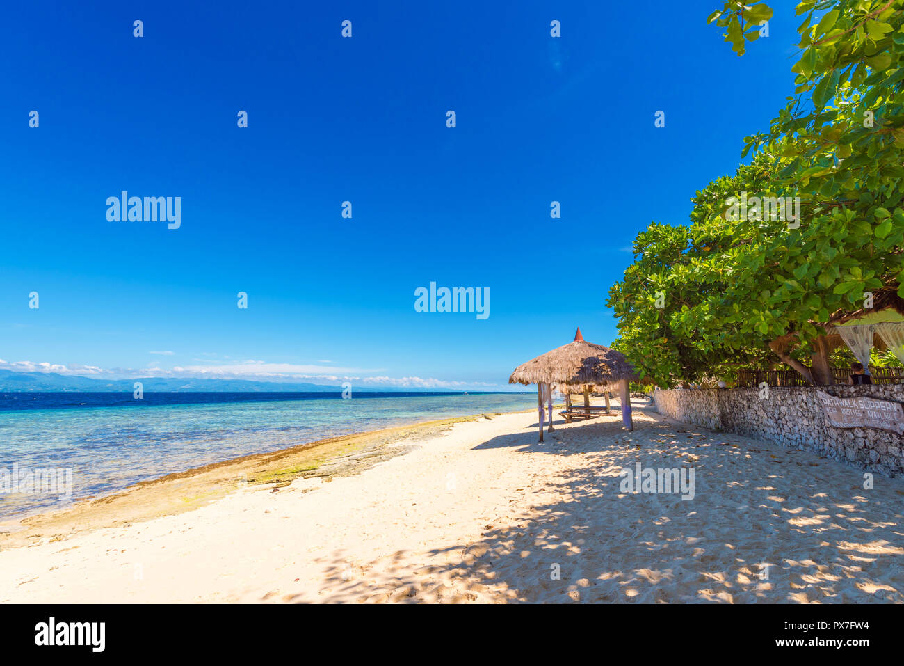 View of the sandy beach in Moalboal, Cebu, Philippines. Copy space for ...