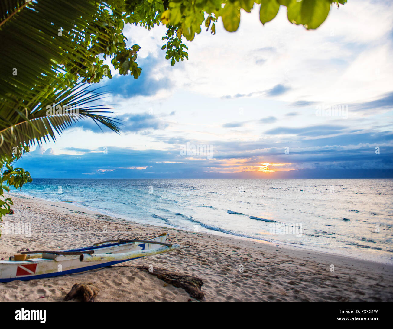 View of the sunset on a sandy beach in Moalboal, Cebu, Philippines ...