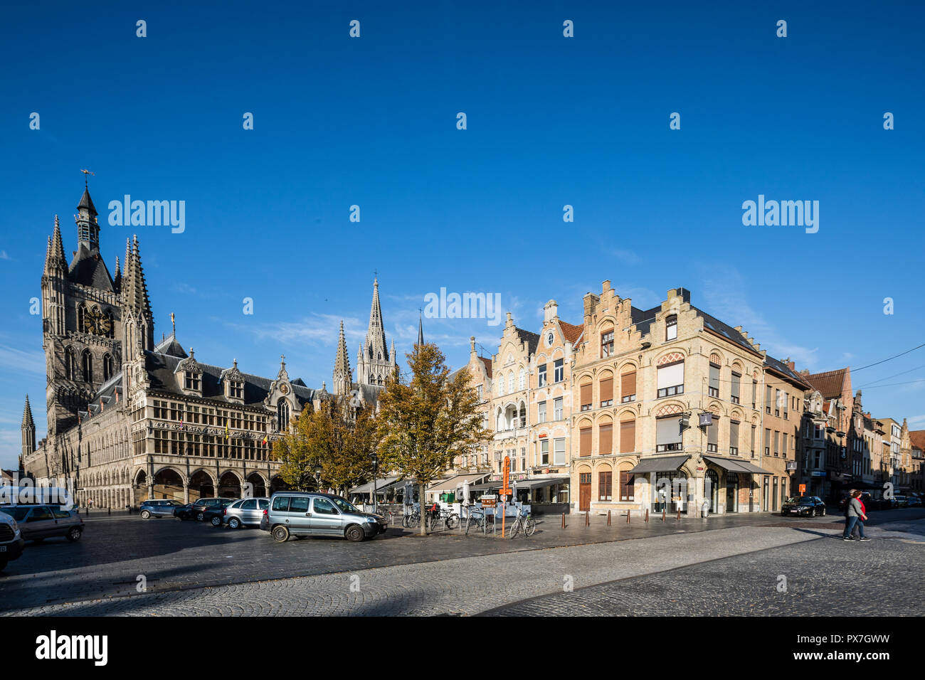 The Cloth Museum and the spire of the Catholic church in Ypres Stock ...