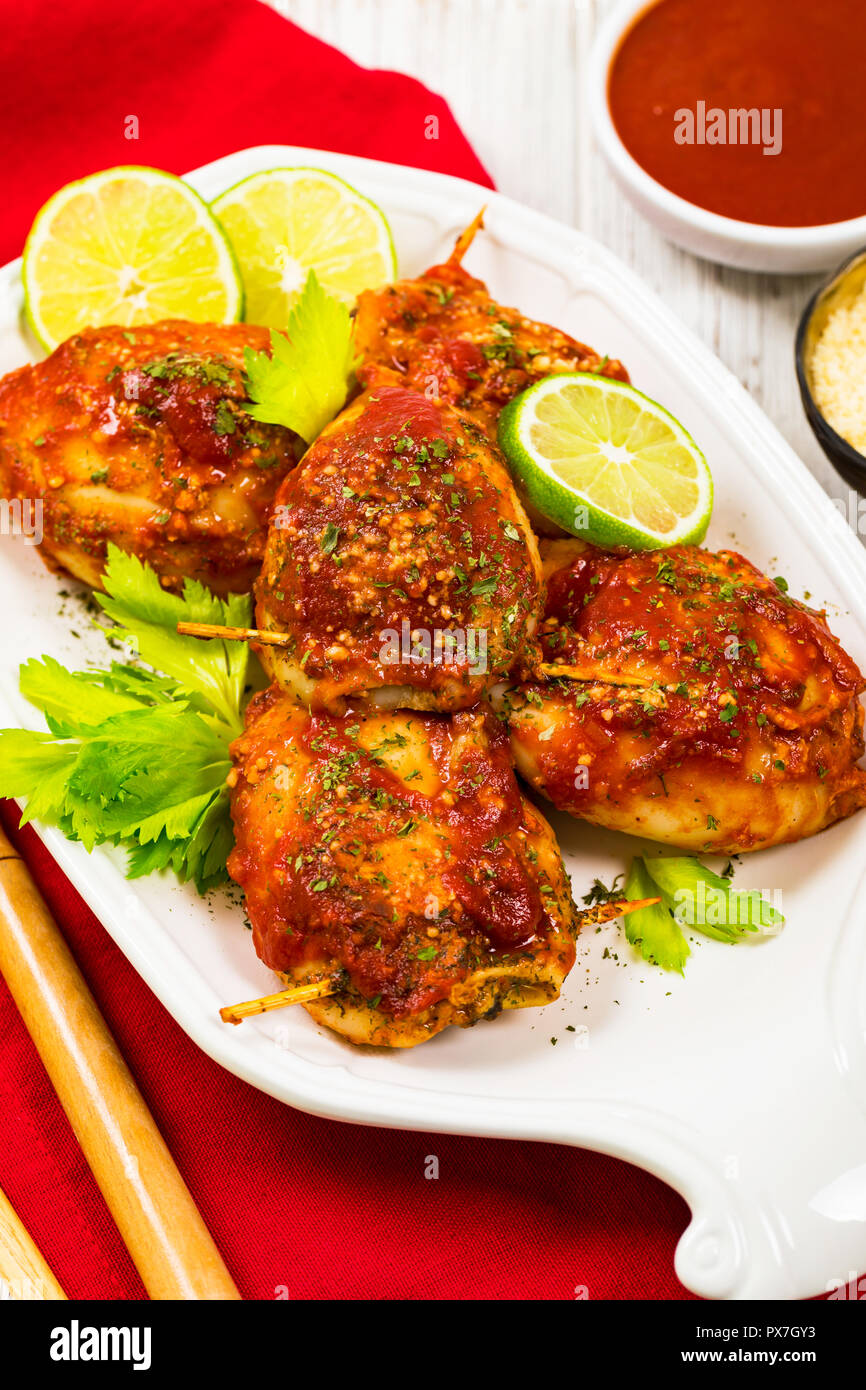 Stuffed Calamari Squid Tubes with Tomato Sauce Stock Photo - Alamy