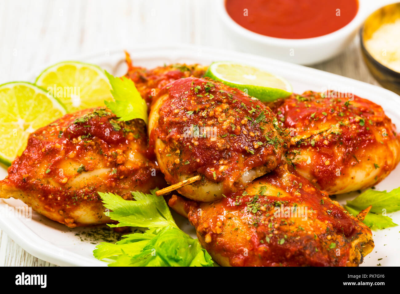 Stuffed Calamari Squid Tubes with Tomato Sauce Stock Photo - Alamy