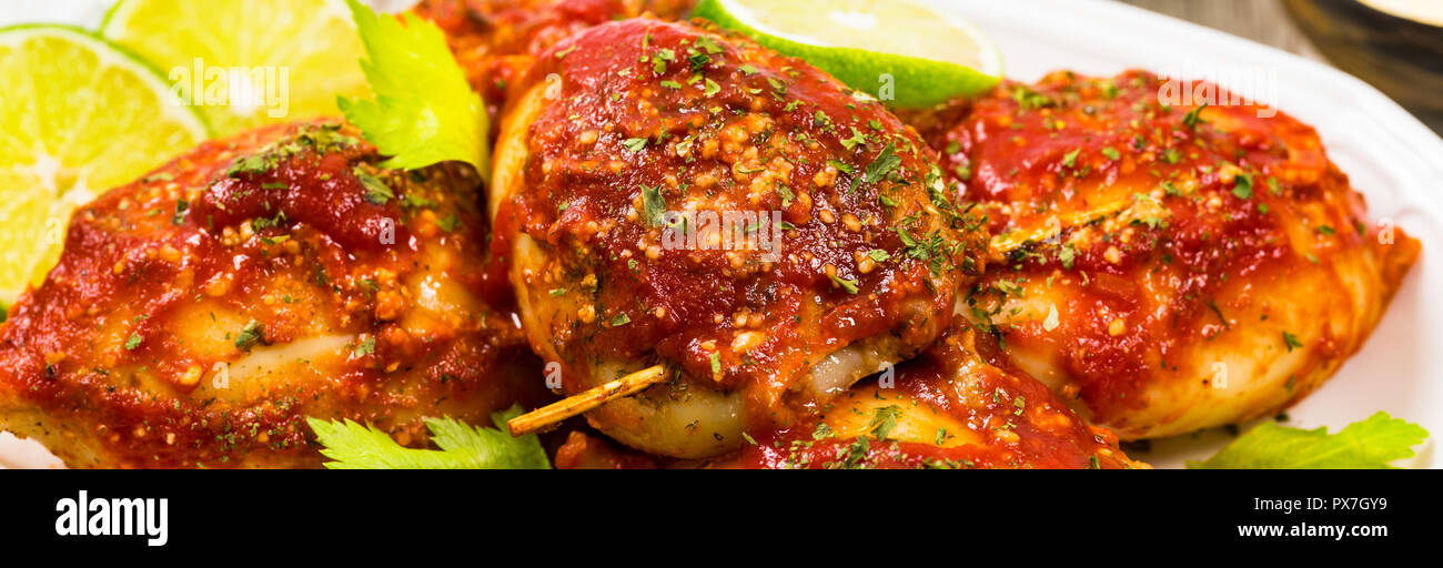 Stuffed Calamari Squid Tubes with Tomato Sauce Stock Photo - Alamy