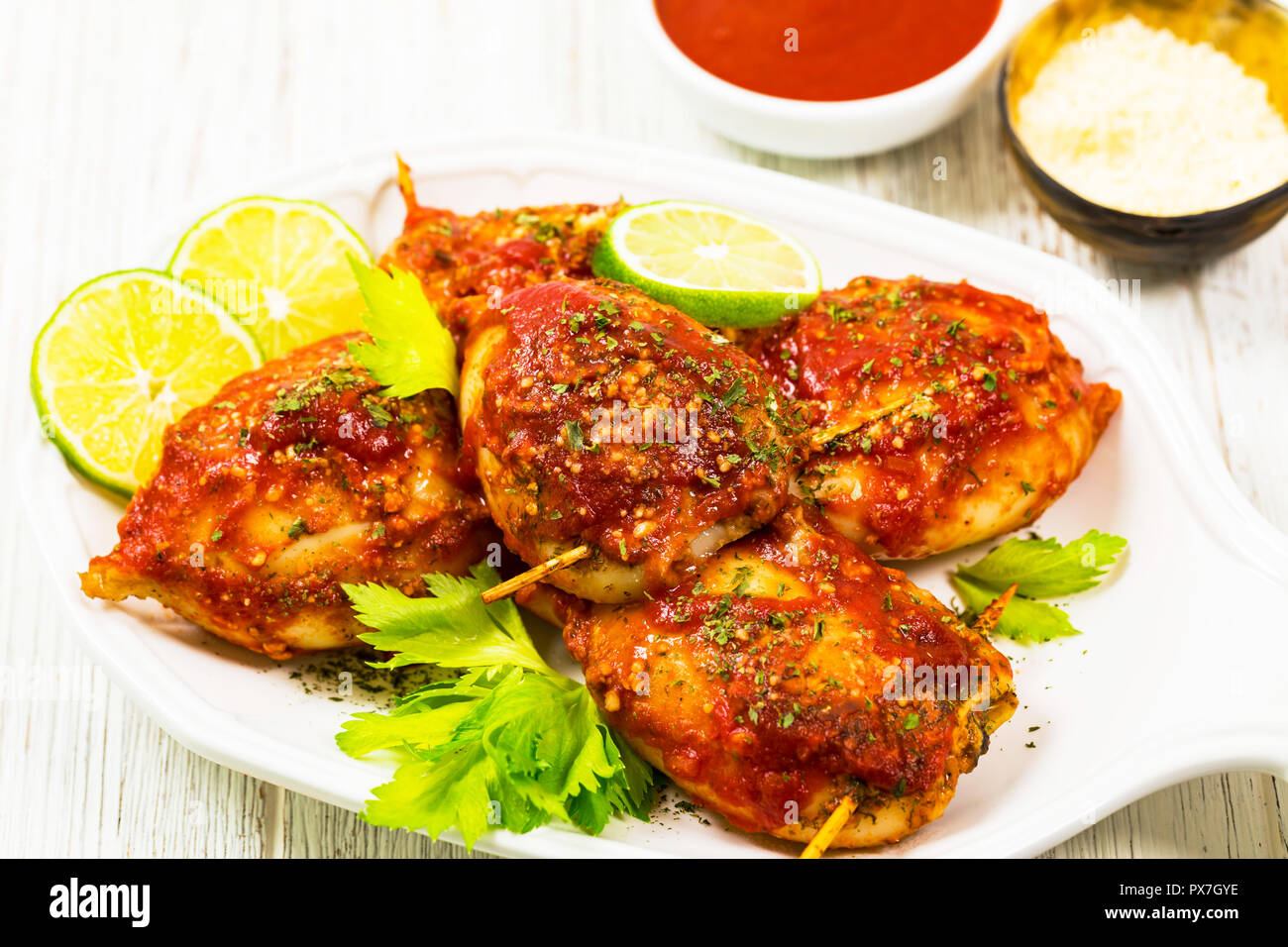 Stuffed Calamari Squid Tubes with Tomato Sauce Stock Photo - Alamy
