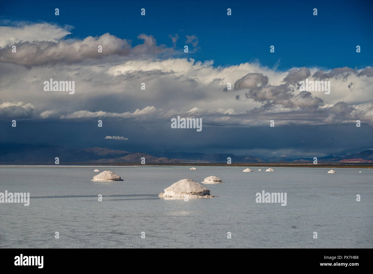 flooded salt in which the sky, clouds and mountains are reflected Stock ...