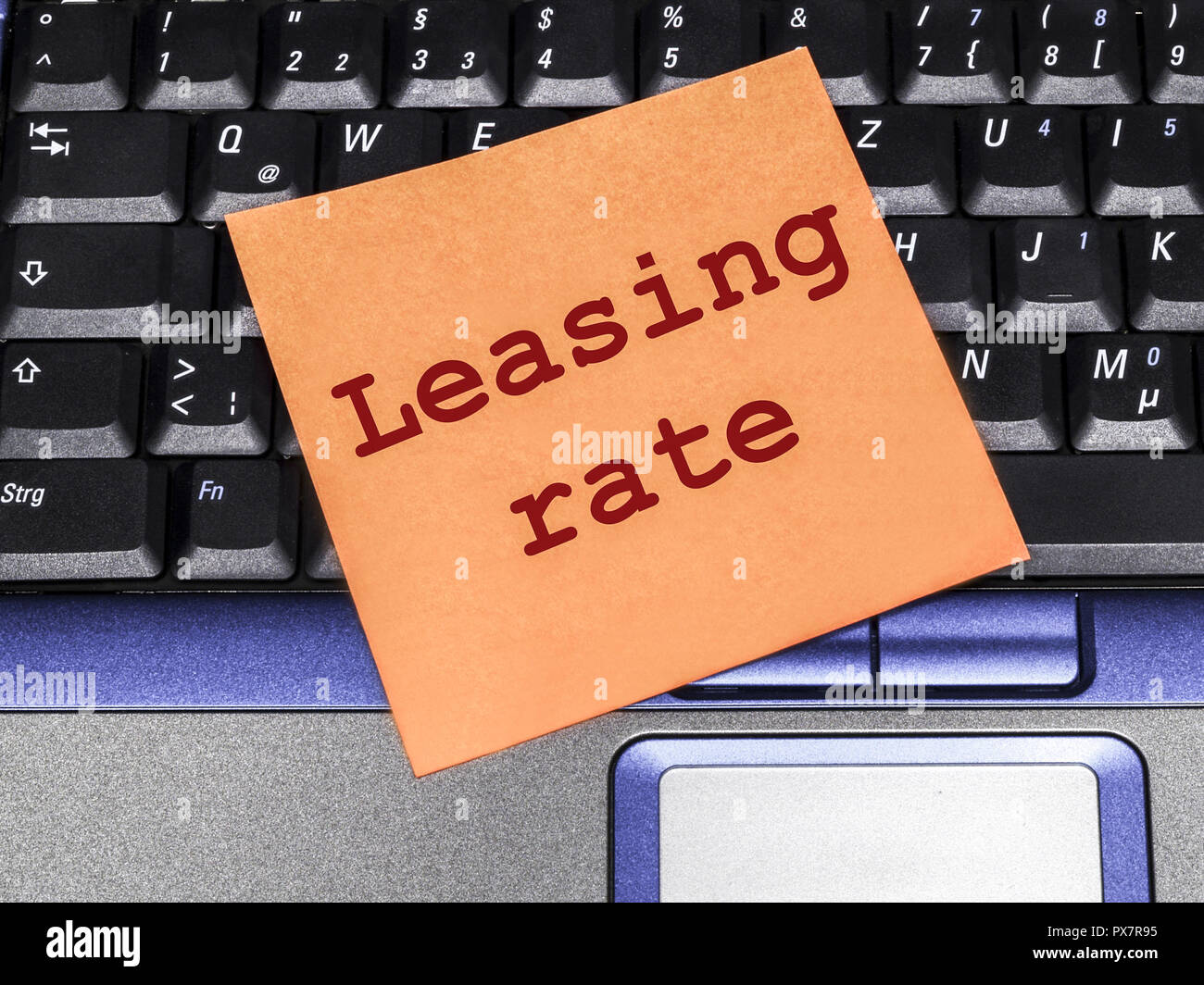 Memo note on notebook, leasing rate Stock Photo - Alamy