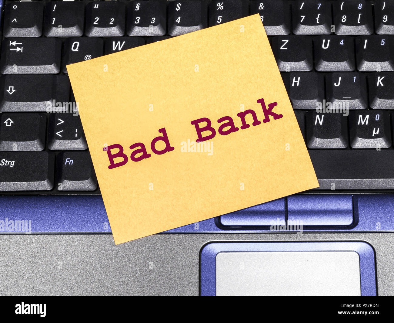 Memo note on notebook, bad bank Stock Photo - Alamy
