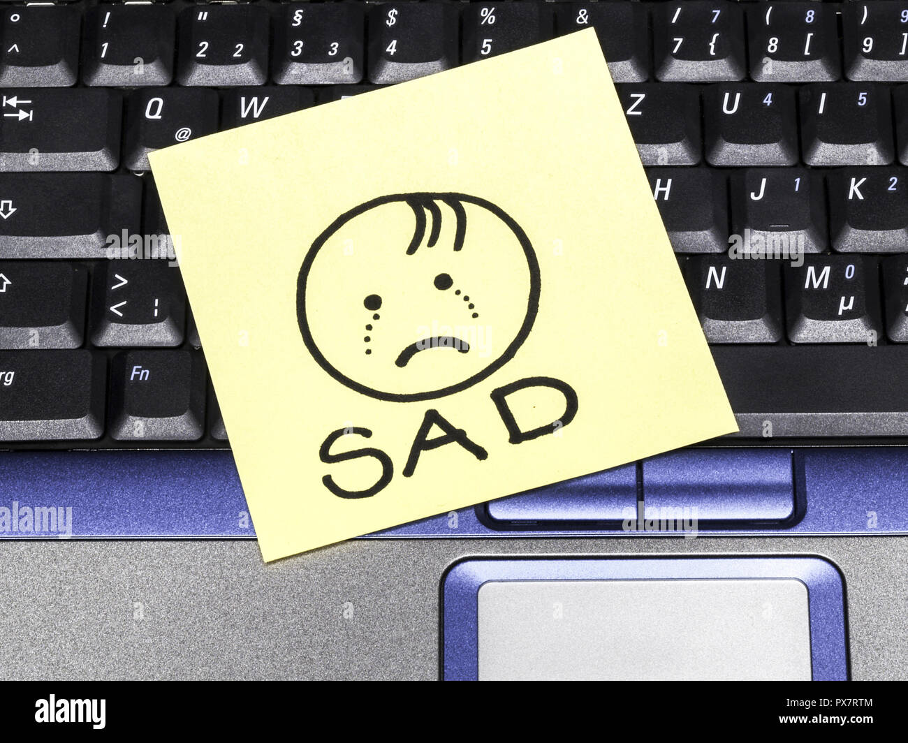 Memo note on notebook, smiley sad drawing Stock Photo - Alamy