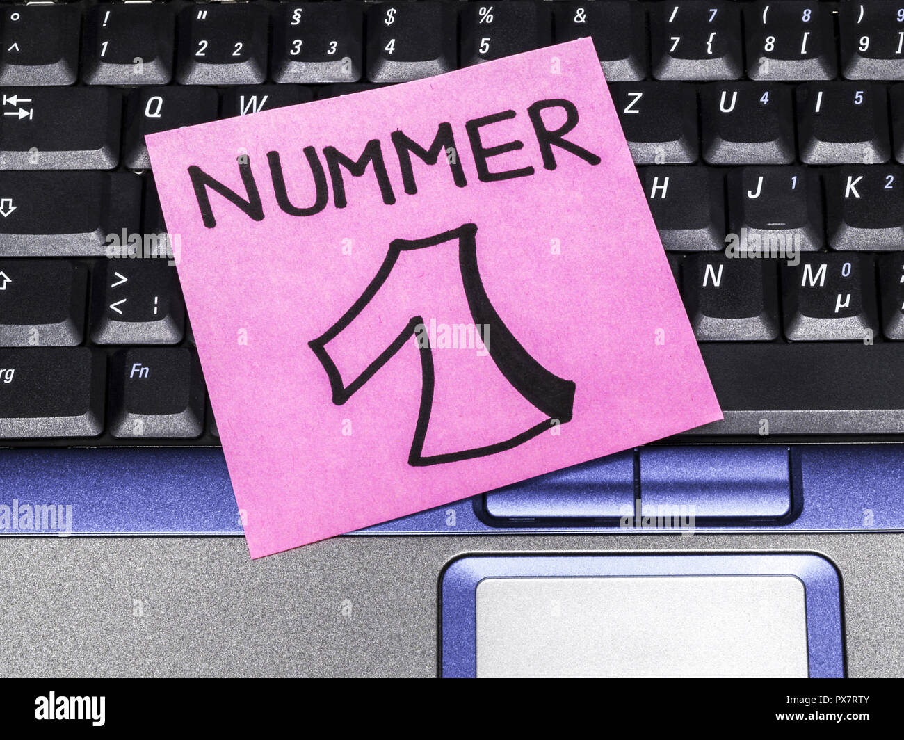Memo note on notebook, nummer number one Stock Photo - Alamy