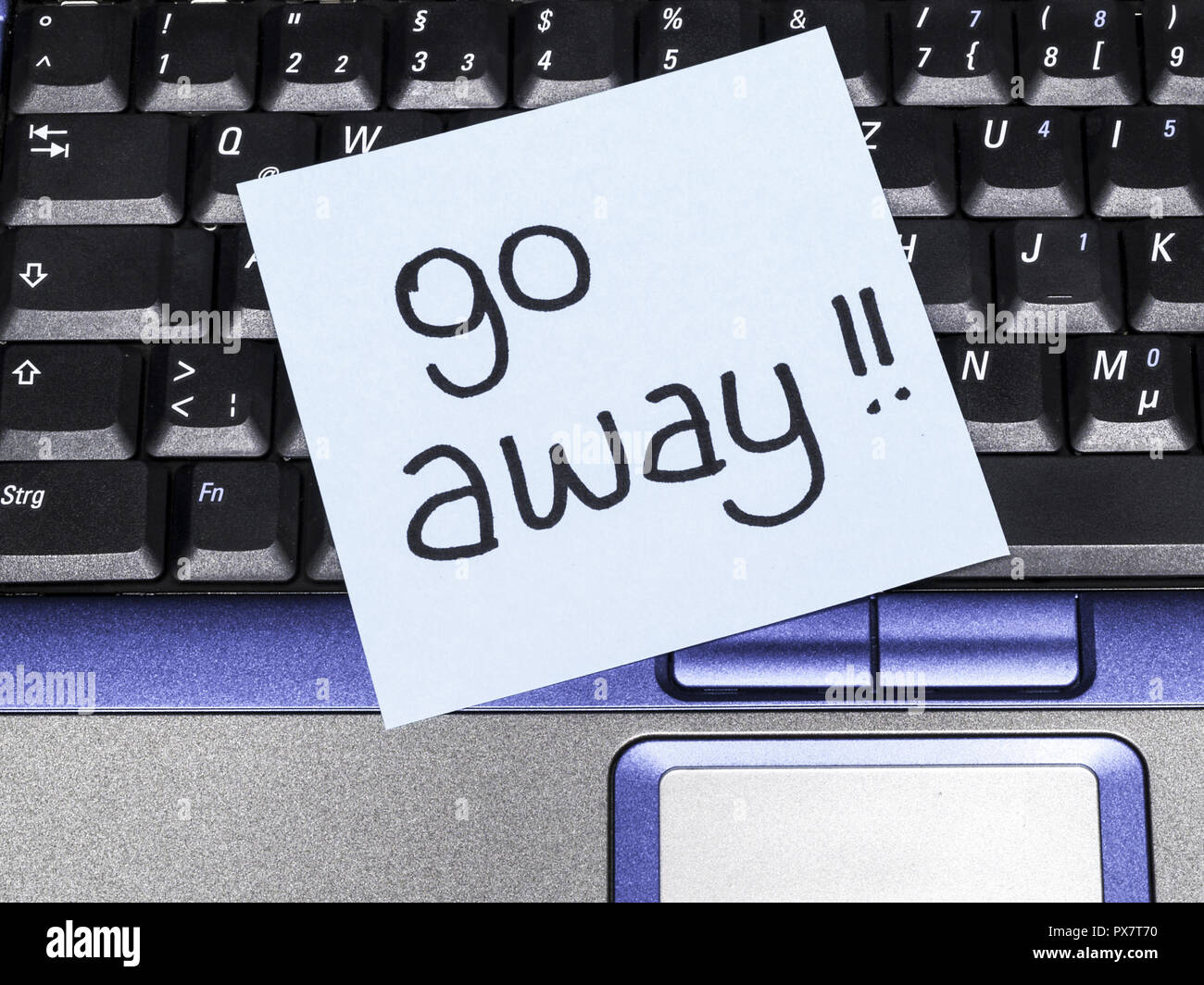 Memo note on notebook, go away Stock Photo - Alamy