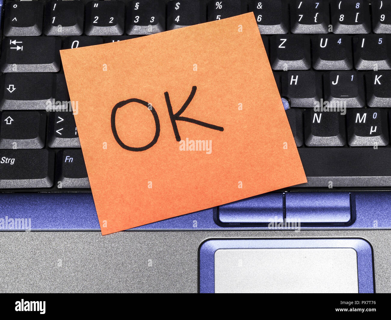 Memo note on notebook, ok Stock Photo - Alamy