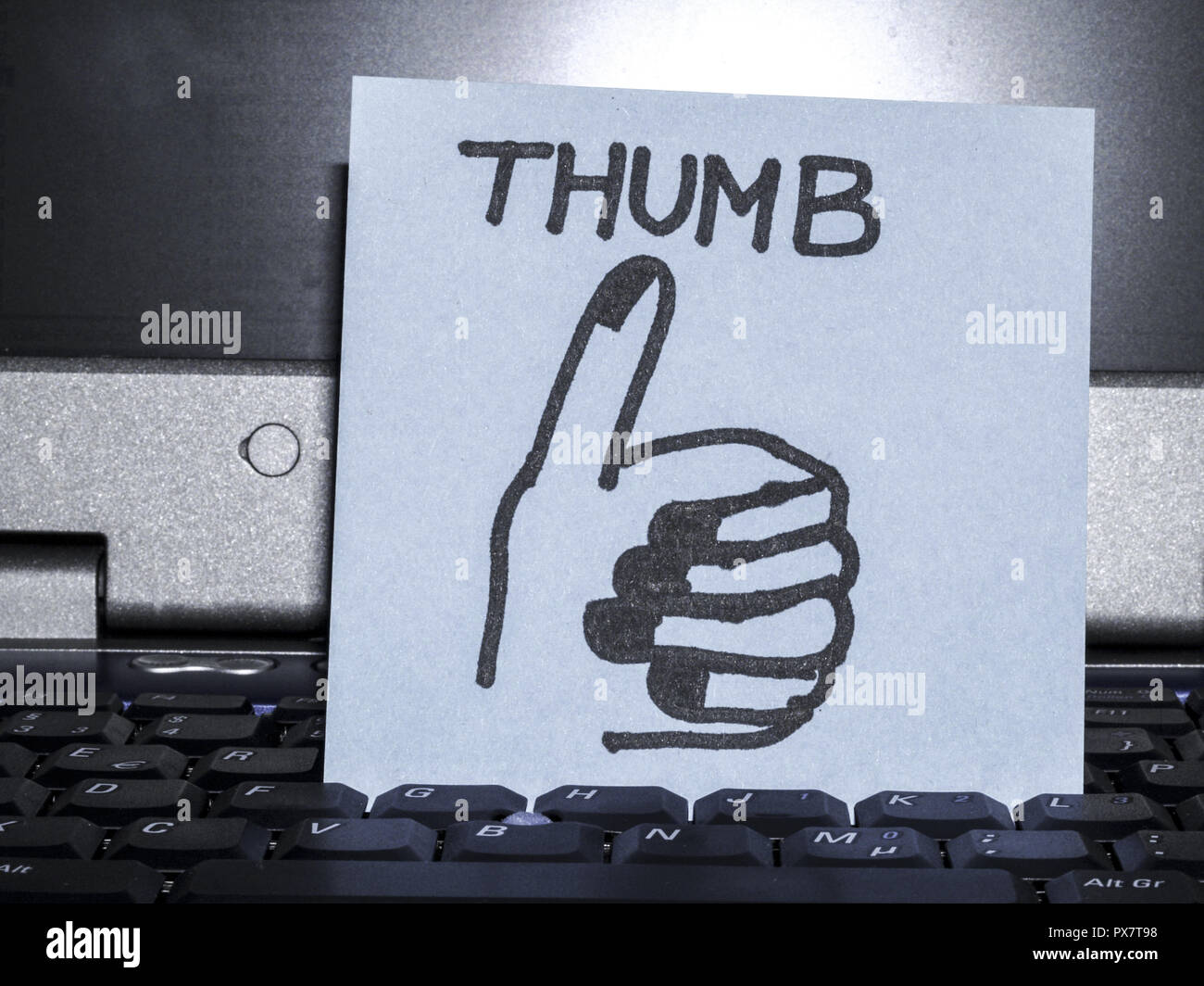 Memo note on notebook, thumb up drawing Stock Photo - Alamy