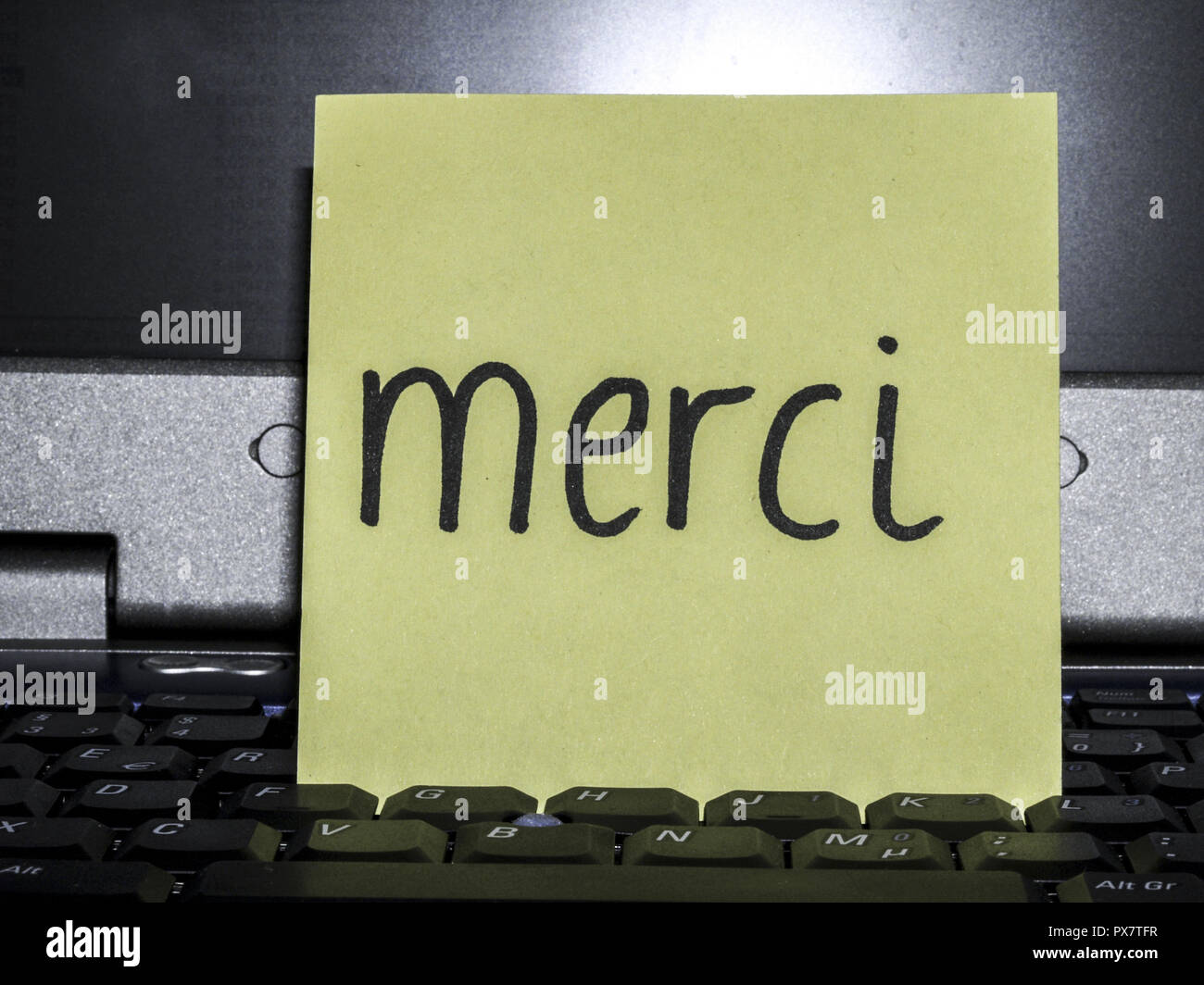 Memo note on notebook, merci, thanks Stock Photo - Alamy