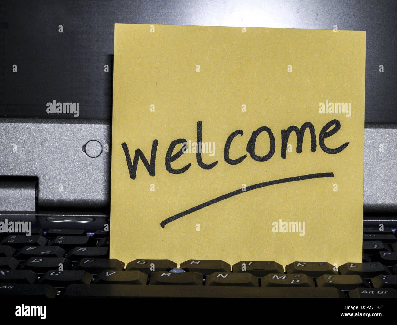 Memo note on notebook, welcome Stock Photo - Alamy
