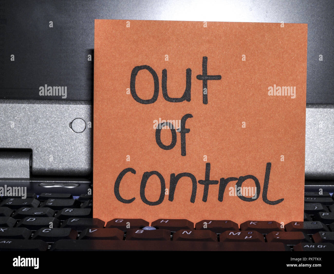 Memo note on notebook, out of control Stock Photo - Alamy