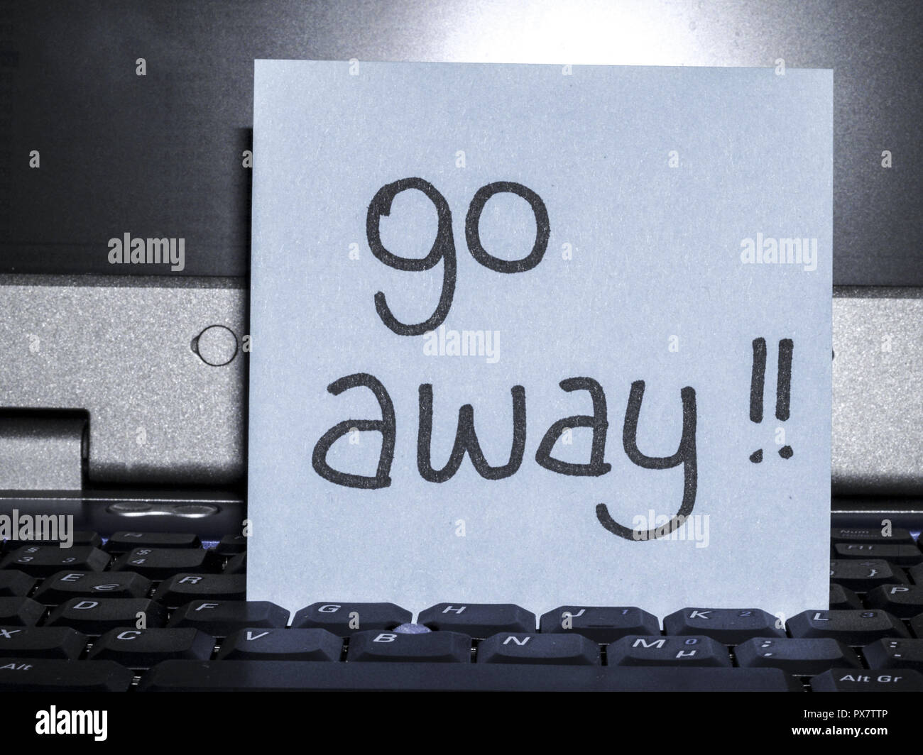 Memo note on notebook, go away Stock Photo - Alamy