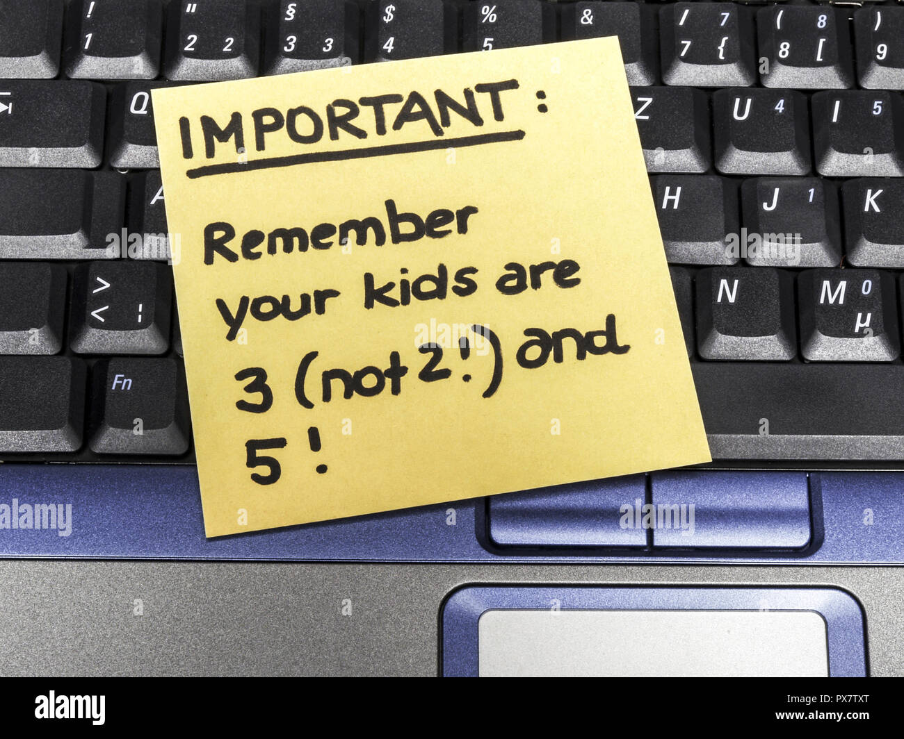 Memo note on notebook, Important, Remember your kids are three (not two ...