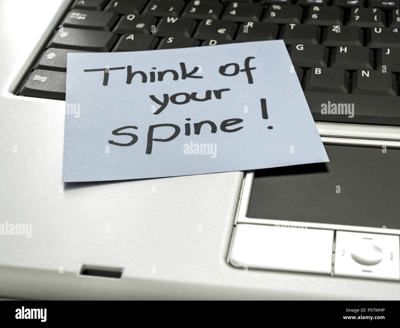 Memo note on notebook, think of your spine Stock Photo - Alamy