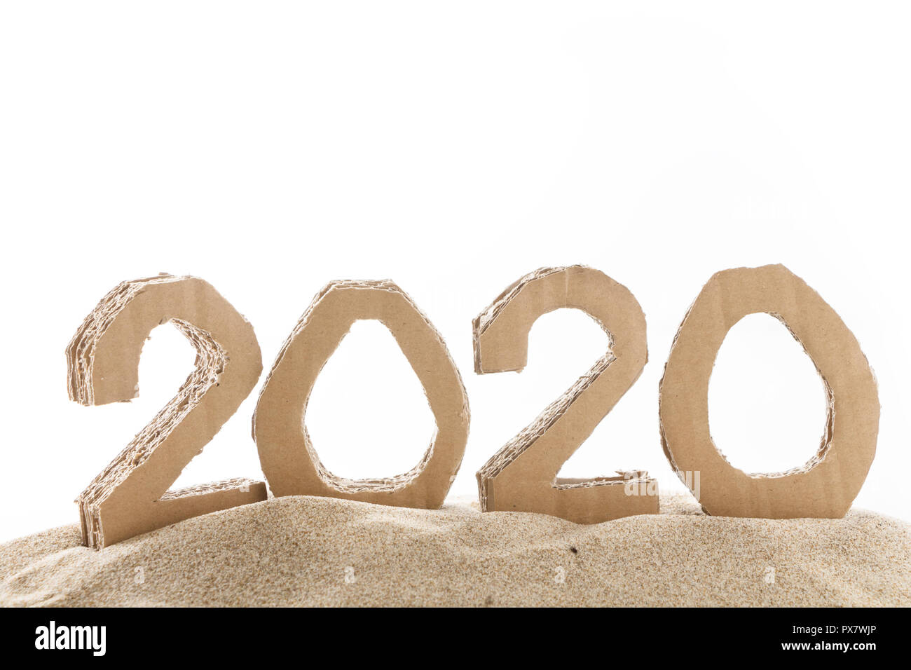 2020, handmade 3D numbers made of reused cardboard paper, on sand and ...