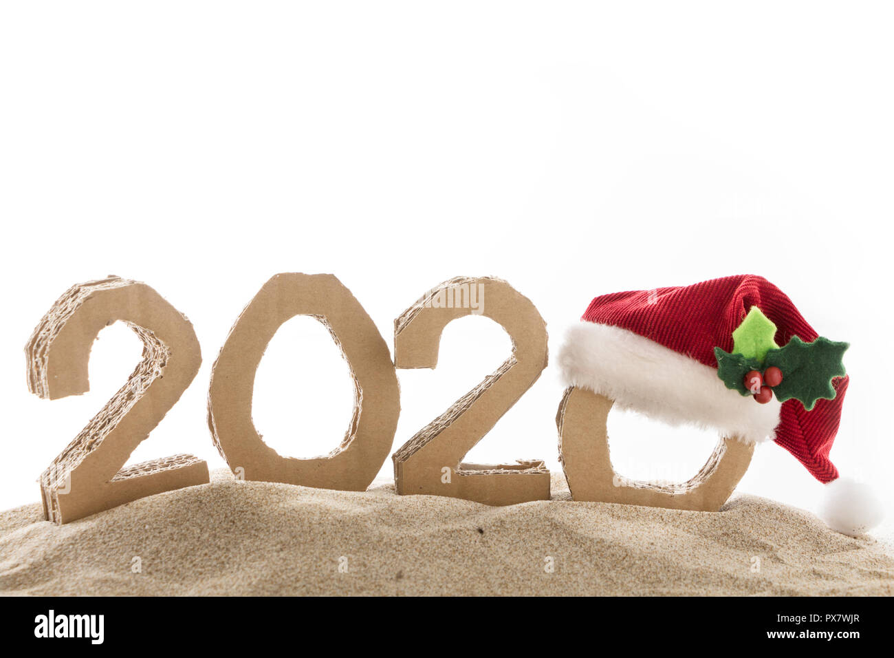 2020, handmade 3D numbers made of reused cardboard paper, on sand and ...