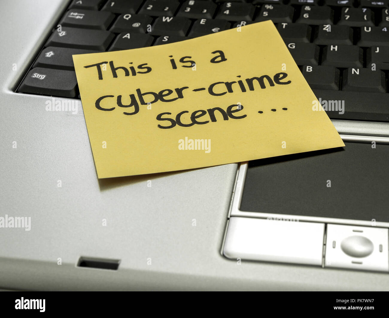 Memo note on notebook, This is a cyber-crime scene Stock Photo - Alamy
