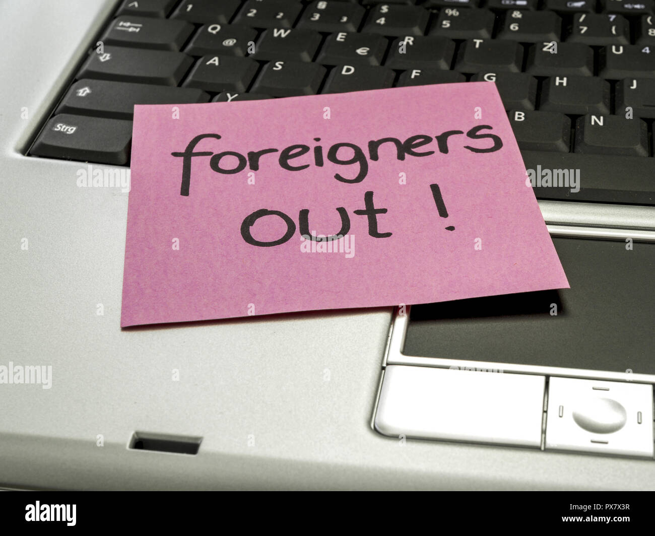 Memo note on notebook, foreigners out Stock Photo - Alamy