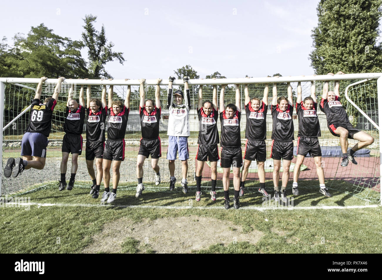 Football team hanging on the crossbar (model-released Stock Photo - Alamy