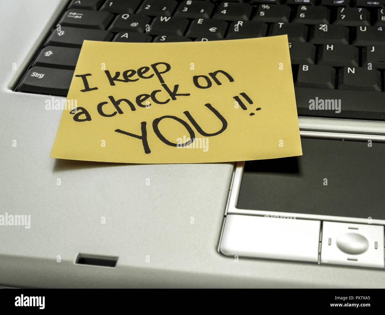 Memo note on notebook, I keep a check on you Stock Photo - Alamy