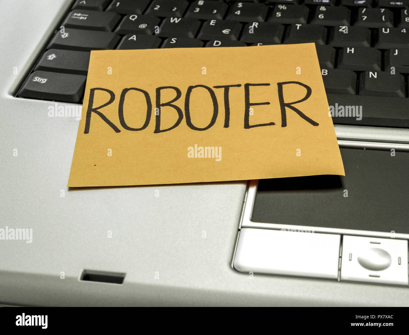Memo note on notebook, robot Stock Photo - Alamy