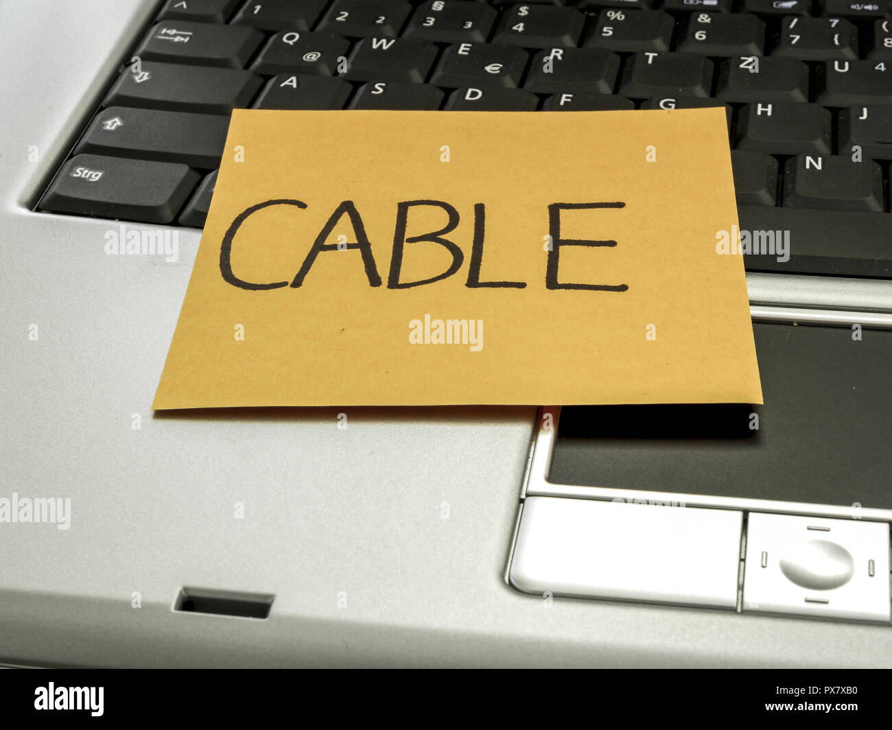 Memo note on notebook, cable Stock Photo - Alamy