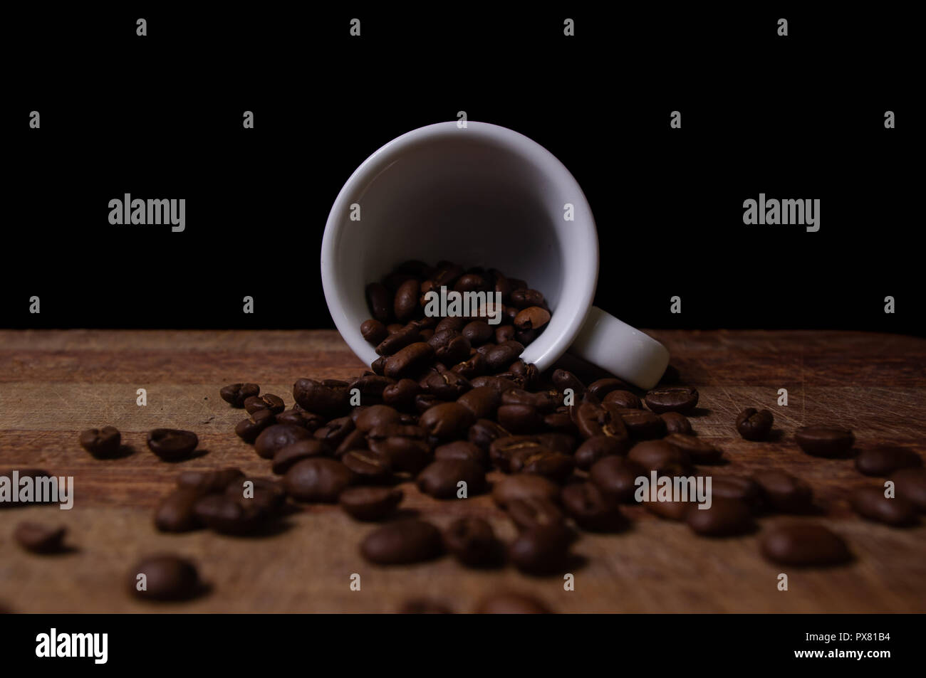 coffee spilt from cup on to wood Stock Photo - Alamy