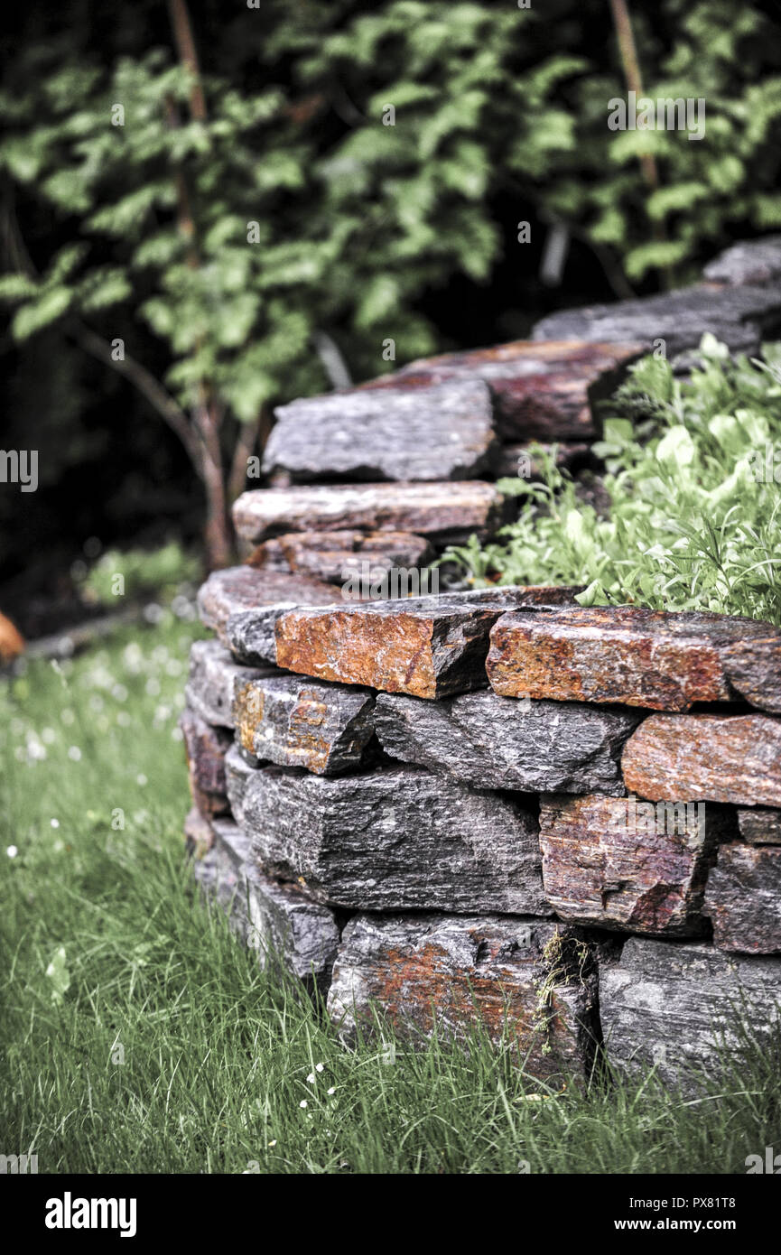 Nature garden with stone wall Stock Photo - Alamy