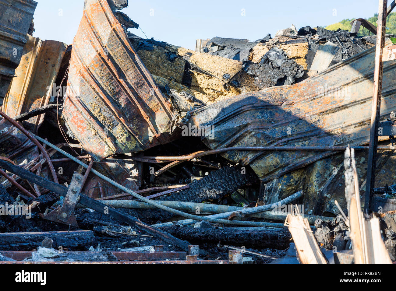 Damaged industry supermarket after arson fire with burn debris of ...