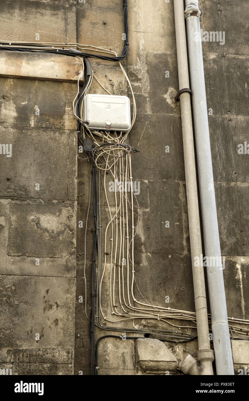 Electric cables at house facade Stock Photo - Alamy