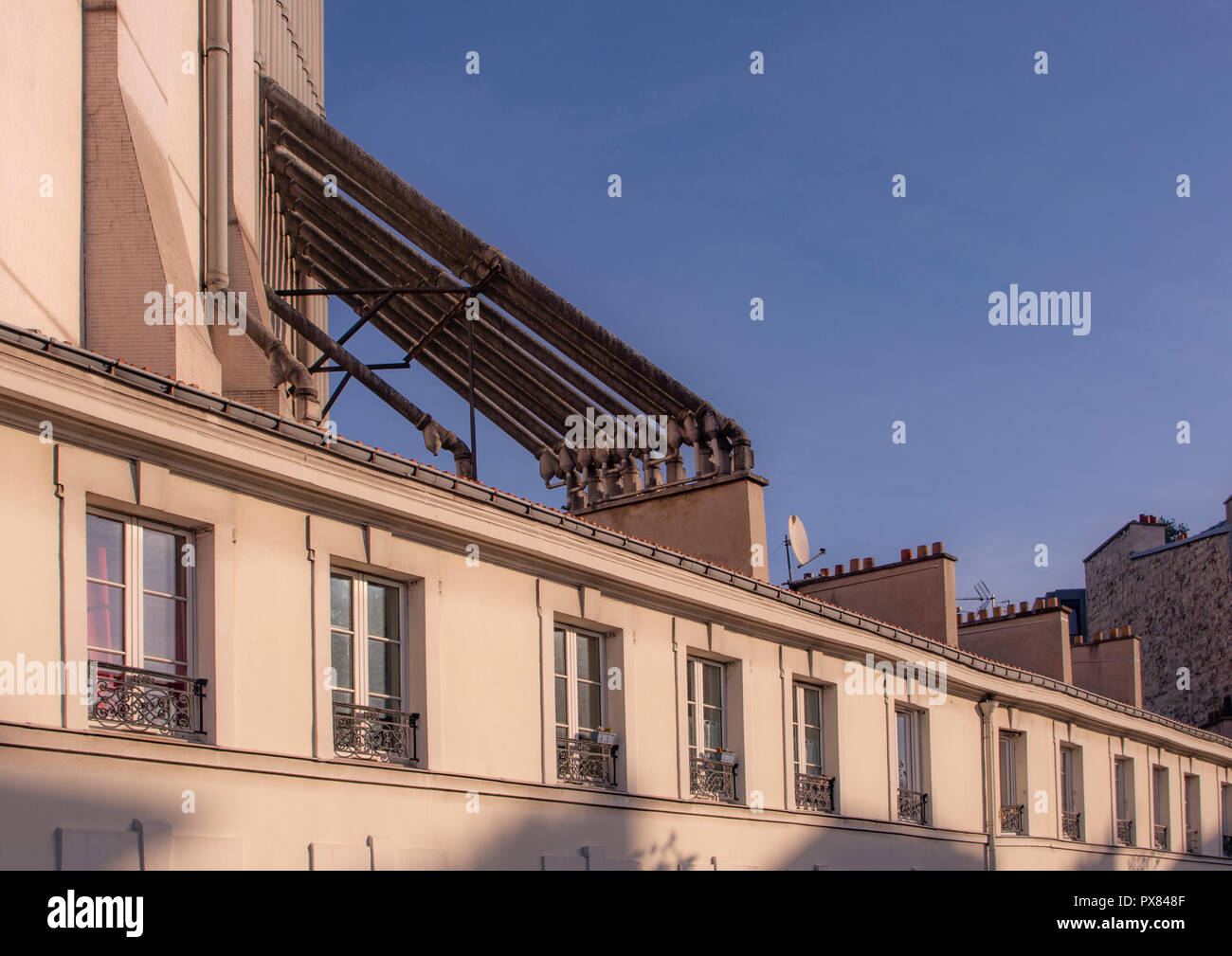 Chimney on the roofs and facades of Paris Stock Photo - Alamy