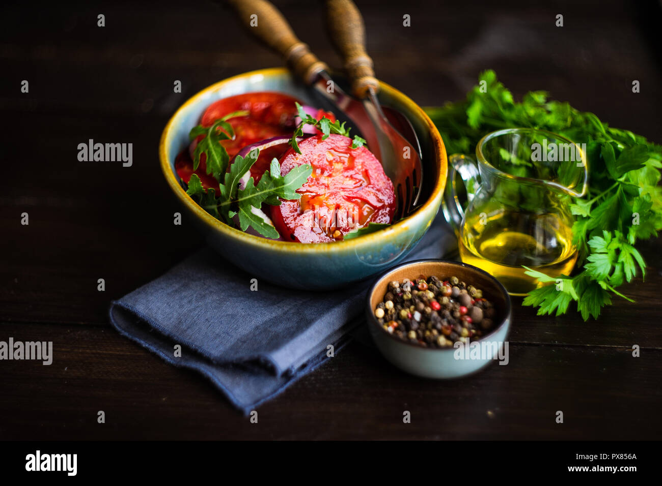 Ceramic bowl full of salad of organic vegetables like a tomato, red ...