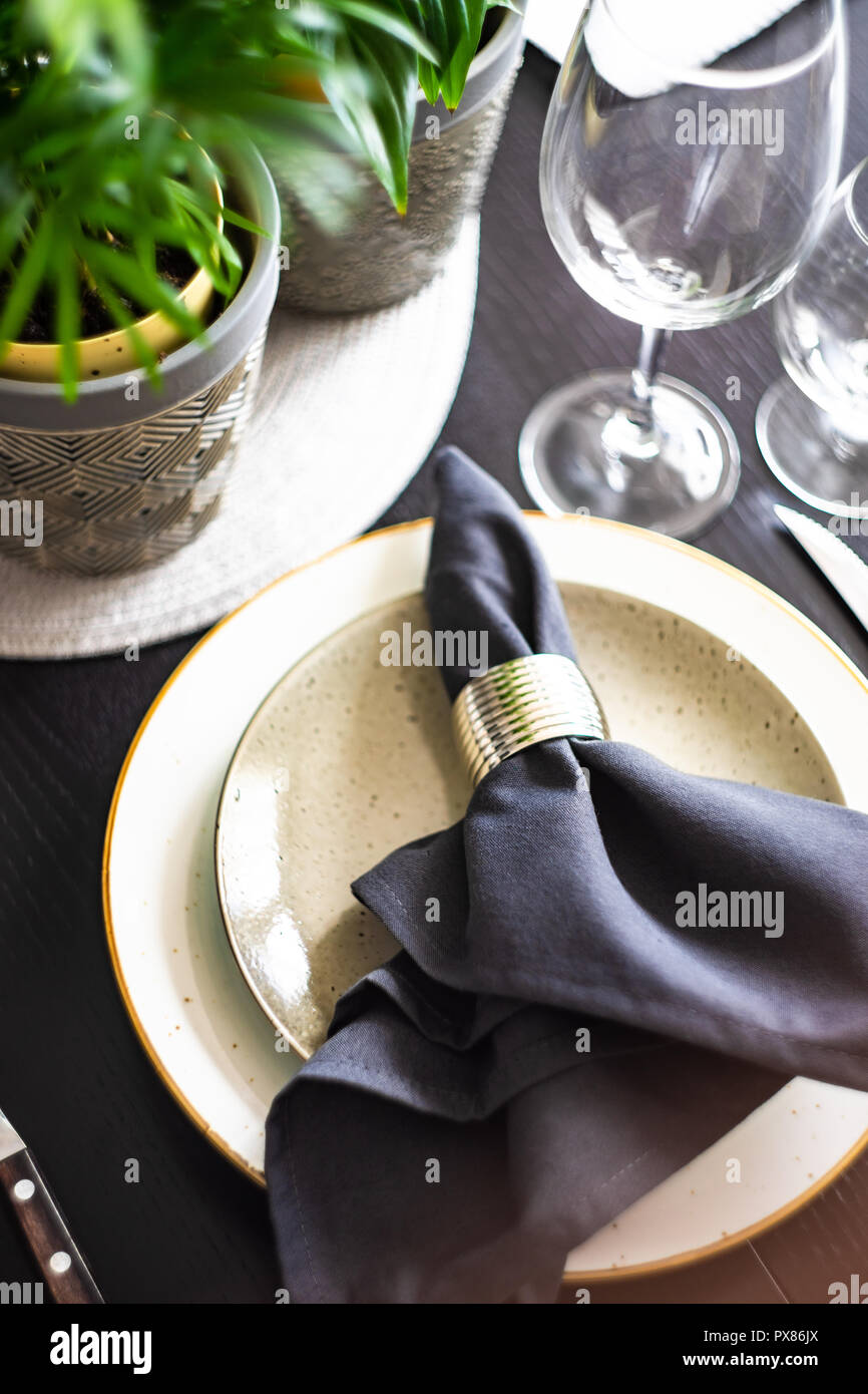 Rustic table setting with ceramic plates, napkin and silverware on dark ...