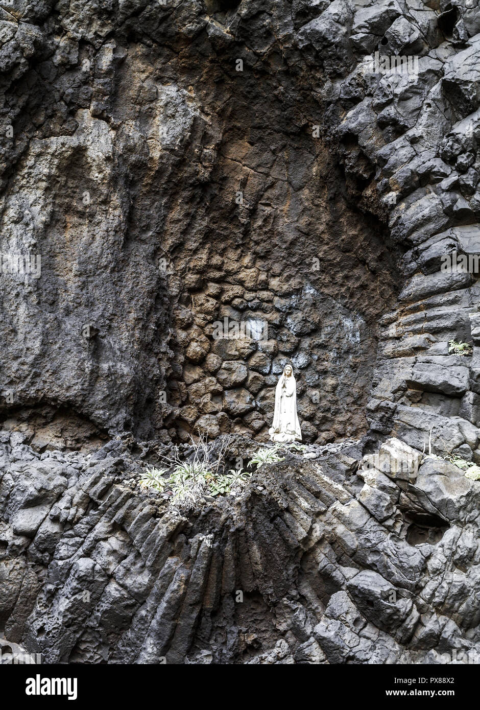 Madonna statue in a rocks recess of igneous rocks, Portugal, Madeira ...