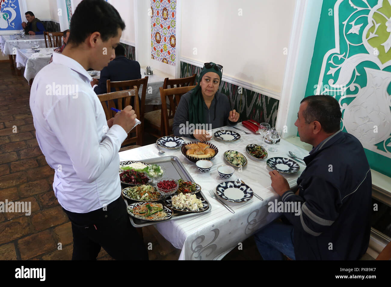 Locals dining in Chayxana Chinar restaurant in the old city of Bukhara ...