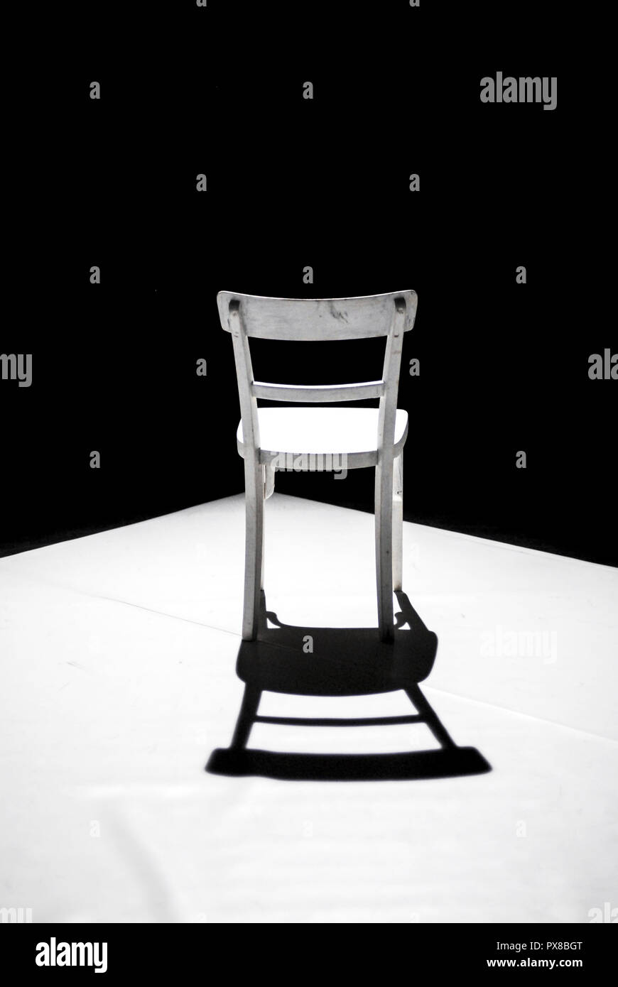 Chair in stage light, shadow Stock Photo - Alamy